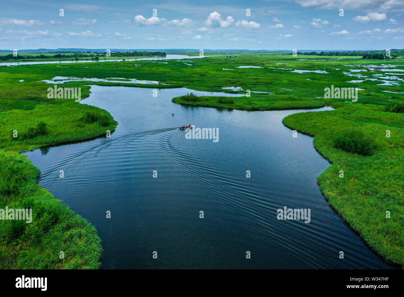 Wide river in Africa, boat crossing the landscape Stock Photo - Alamy