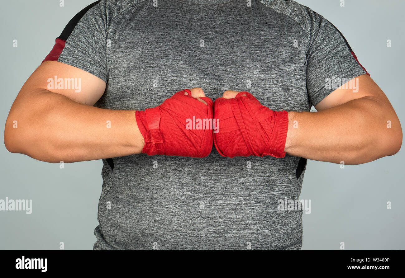 athlete in gray clothes joined his hands in front of his chest, two ...