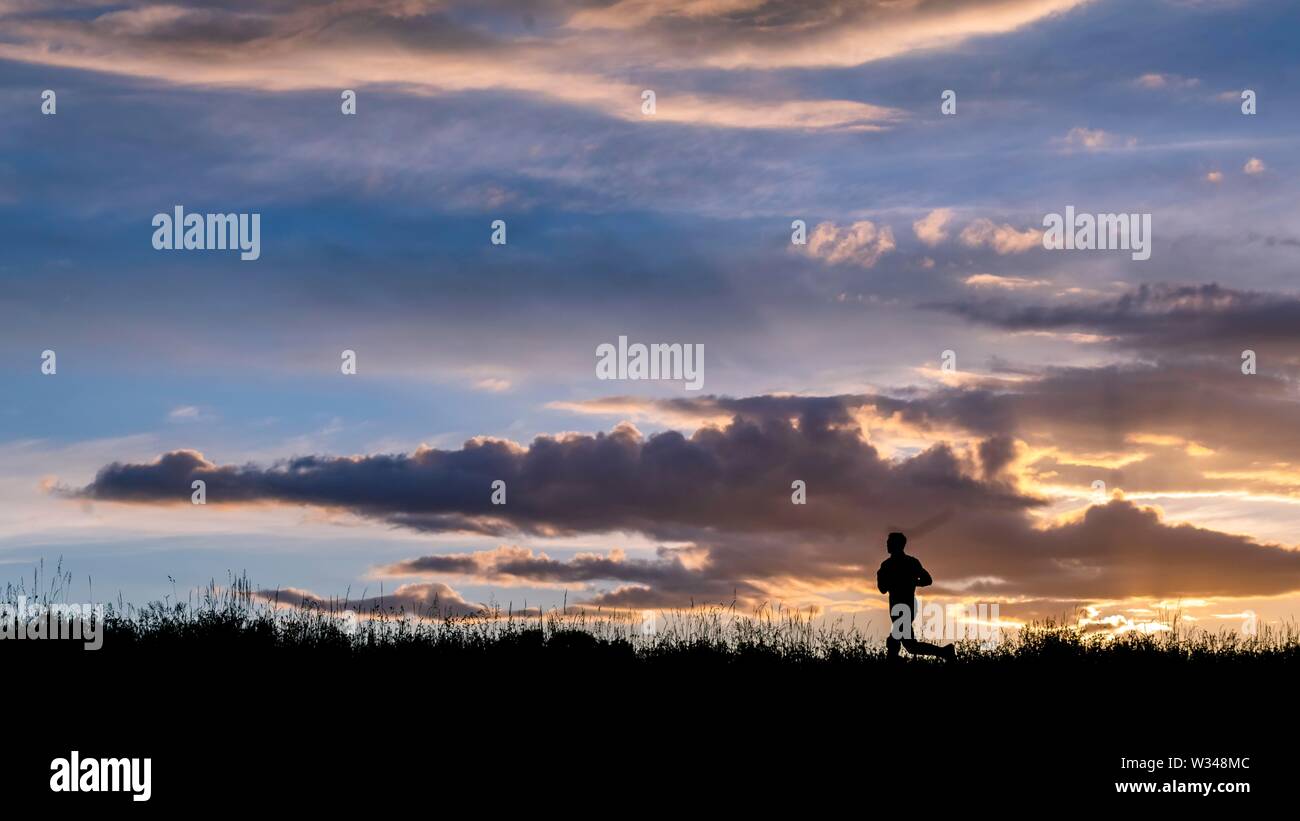 Silhouette, man jogging at sunset, Germany Stock Photo - Alamy