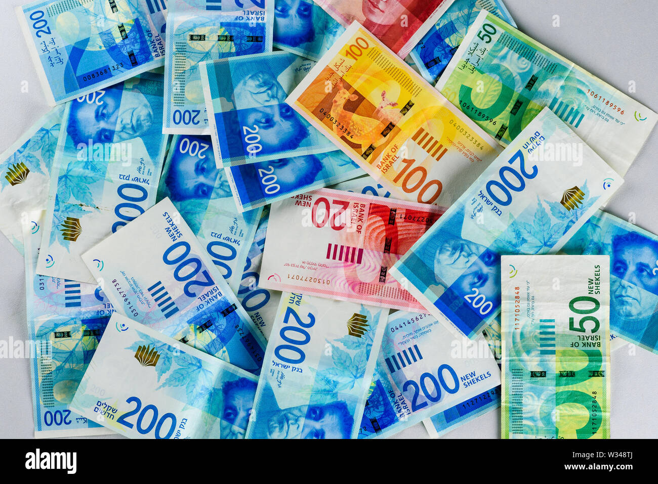 Pile of NIS - New Israeli Shekels banknotes with the new 200, 100, 20 ...