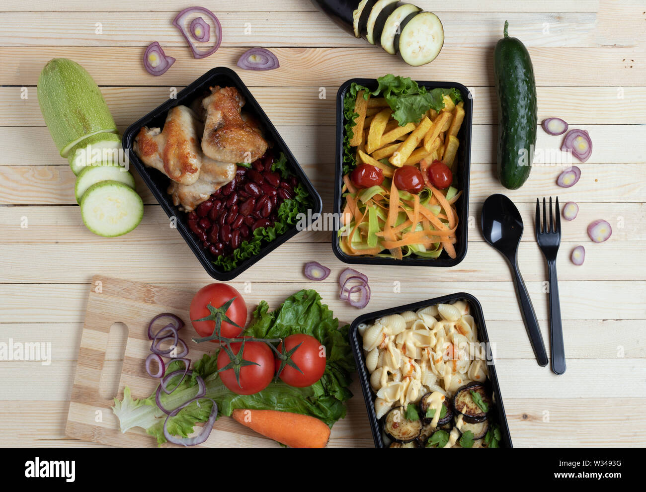 ready meal to eat in food containers on wooden table, flat lay and copy ...
