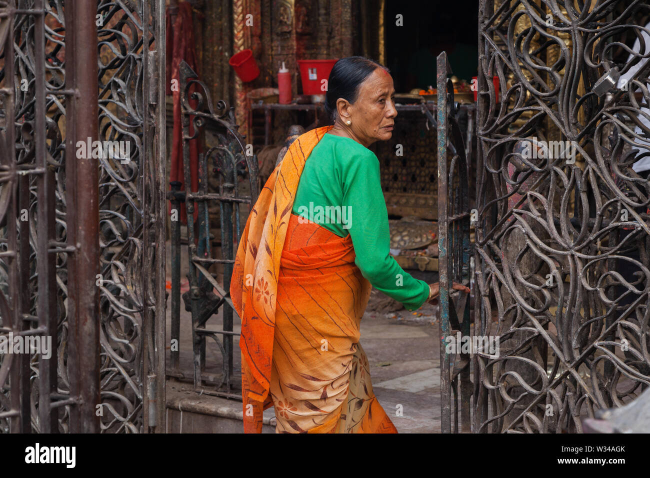 Elderly women entering a small temple to pray Stock Photo - Alamy