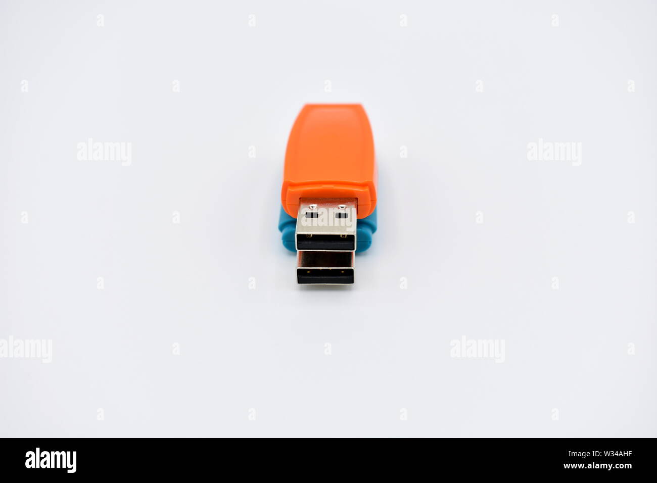 USB flash memory drives with colours, orange, blue and red, on a white ...