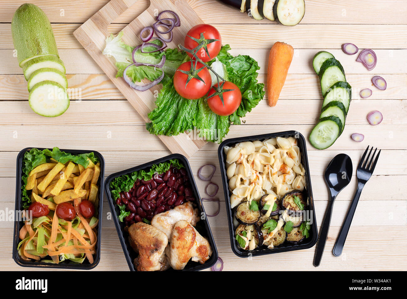 fork and spoon, plastic boxes with ready meal to eat Stock Photo - Alamy