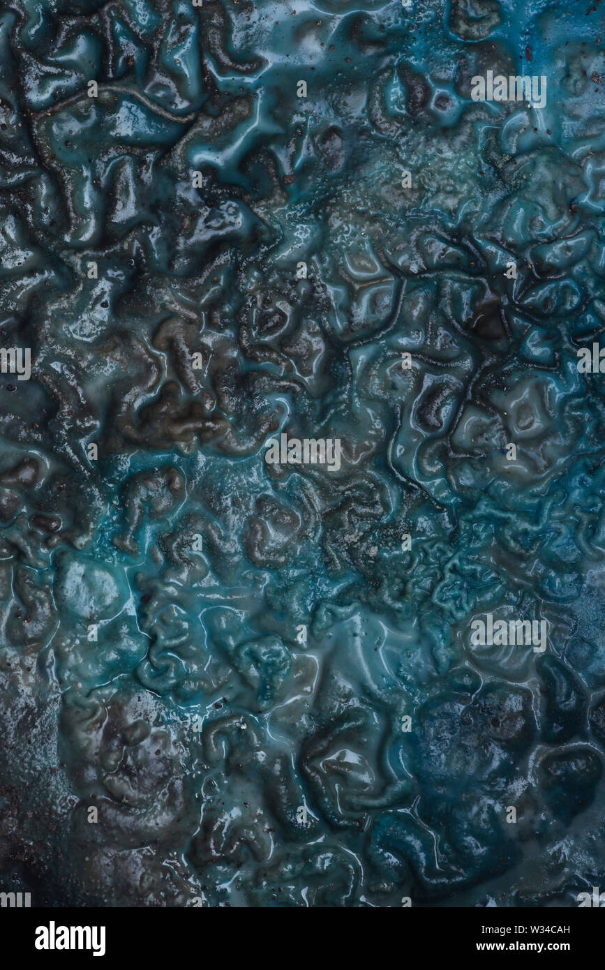 The wrinkled and contorted surface of skinned over old paint, could be ...