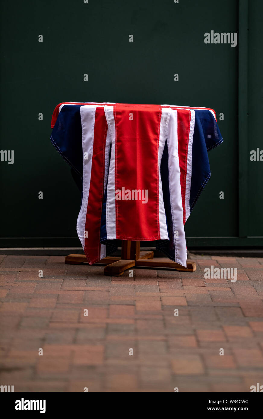 A presentation table draped with a flag on day eleven of the Wimbledon ...