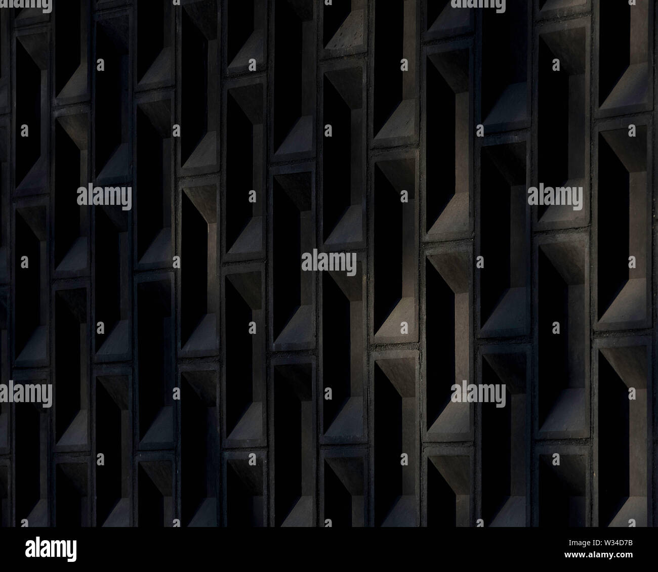 Deep relief tiles caught in oblique sunlight to create a graphic ...