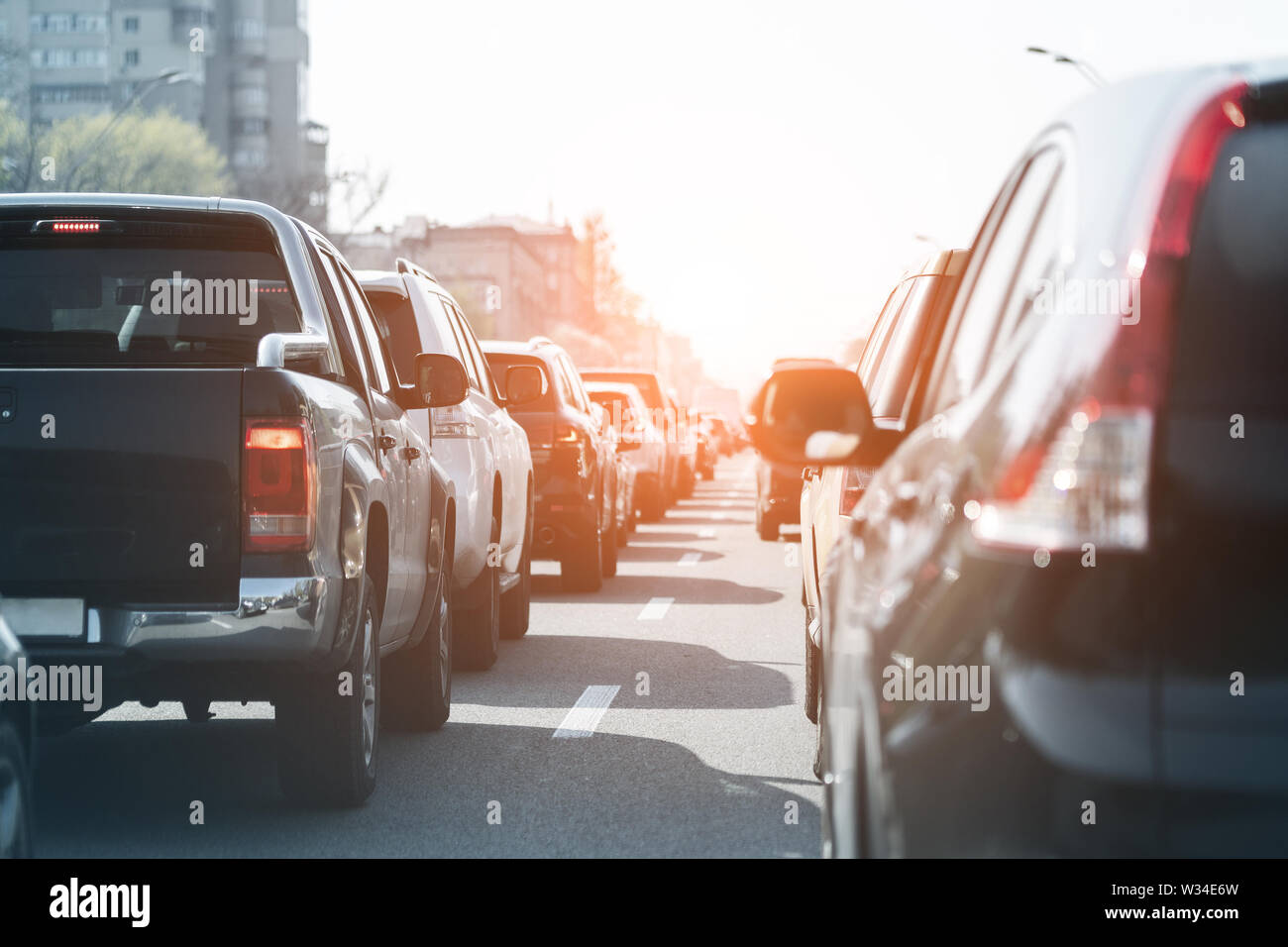Evening traffic jam on busy city highway. Rows of car stck on road due ...