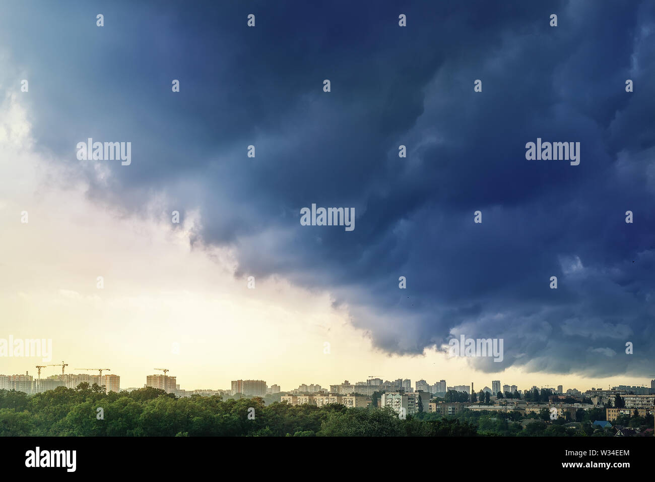 Cityscape covered with dramatic stormy dark clouds before heavy rain ...