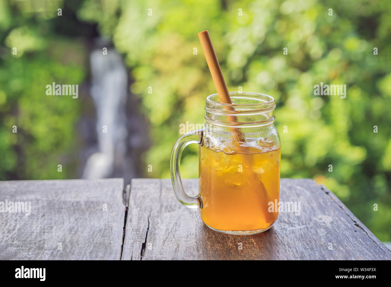 Iced tea on the background of waterfalls Stock Photo - Alamy