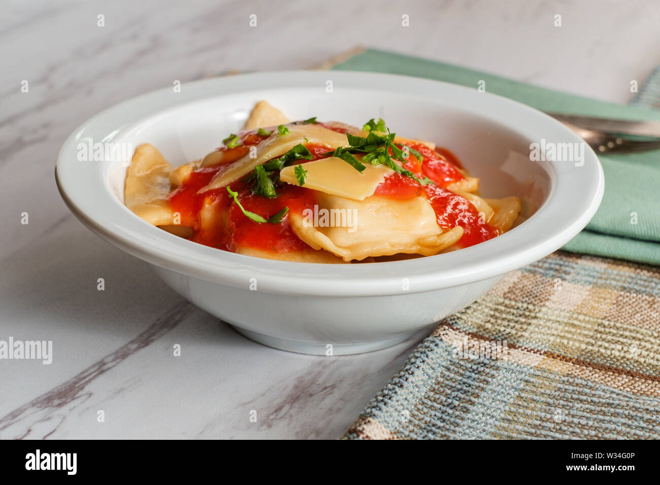 Square shaped meat raviolis with Italian marinara tomato sauce Stock ...