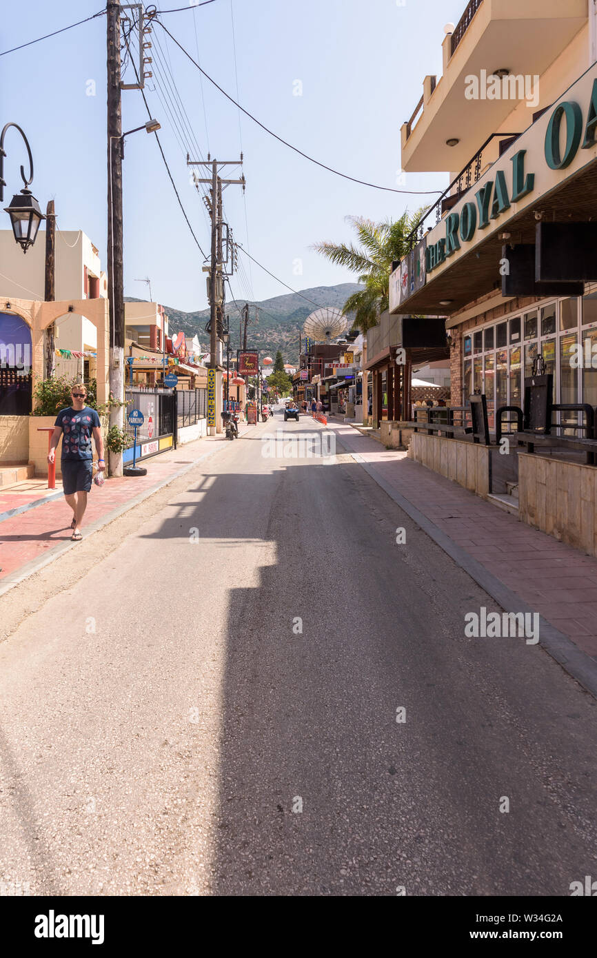 Malia, Crete, Greece - May 27, 2019. Daytime view of the street in ...