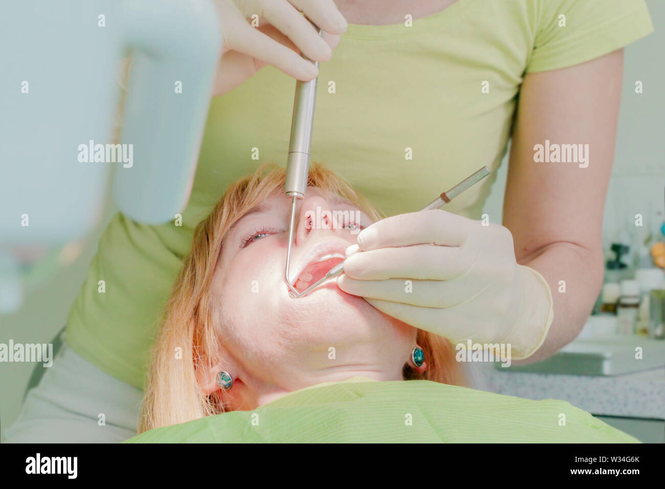 Dentist use LED light and mouth mirror to carry out a full examination ...