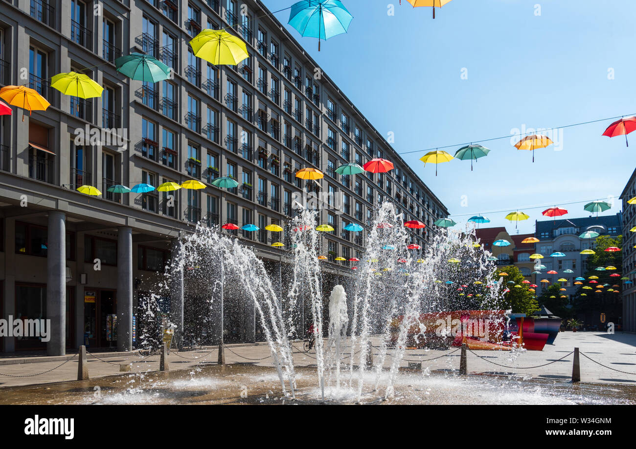 Colourful umbrellas suspended across Walter Benjamin Platz square in ...