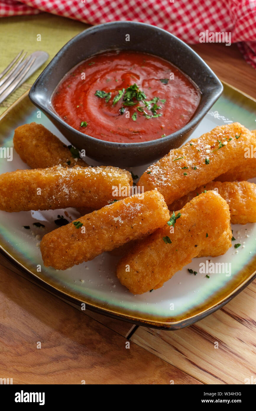 Breaded fried mozzarella cheese sticks with tomato marinara dipping ...