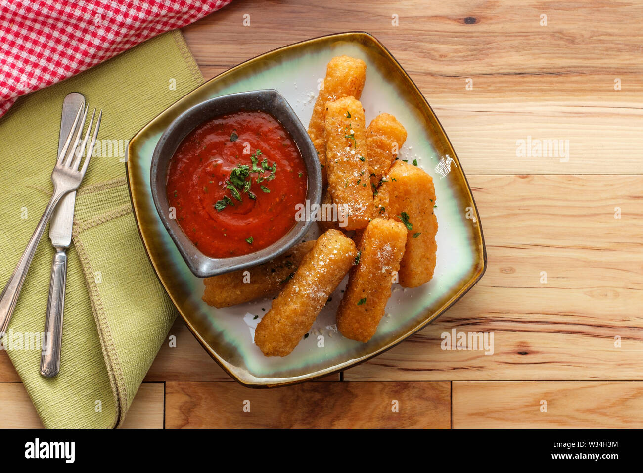 Breaded fried mozzarella cheese sticks with tomato marinara dipping ...