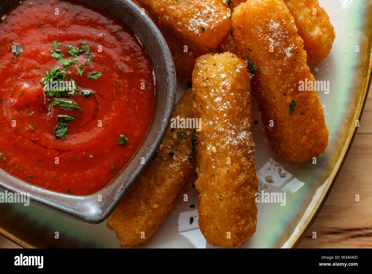 Breaded fried mozzarella cheese sticks with tomato marinara dipping ...