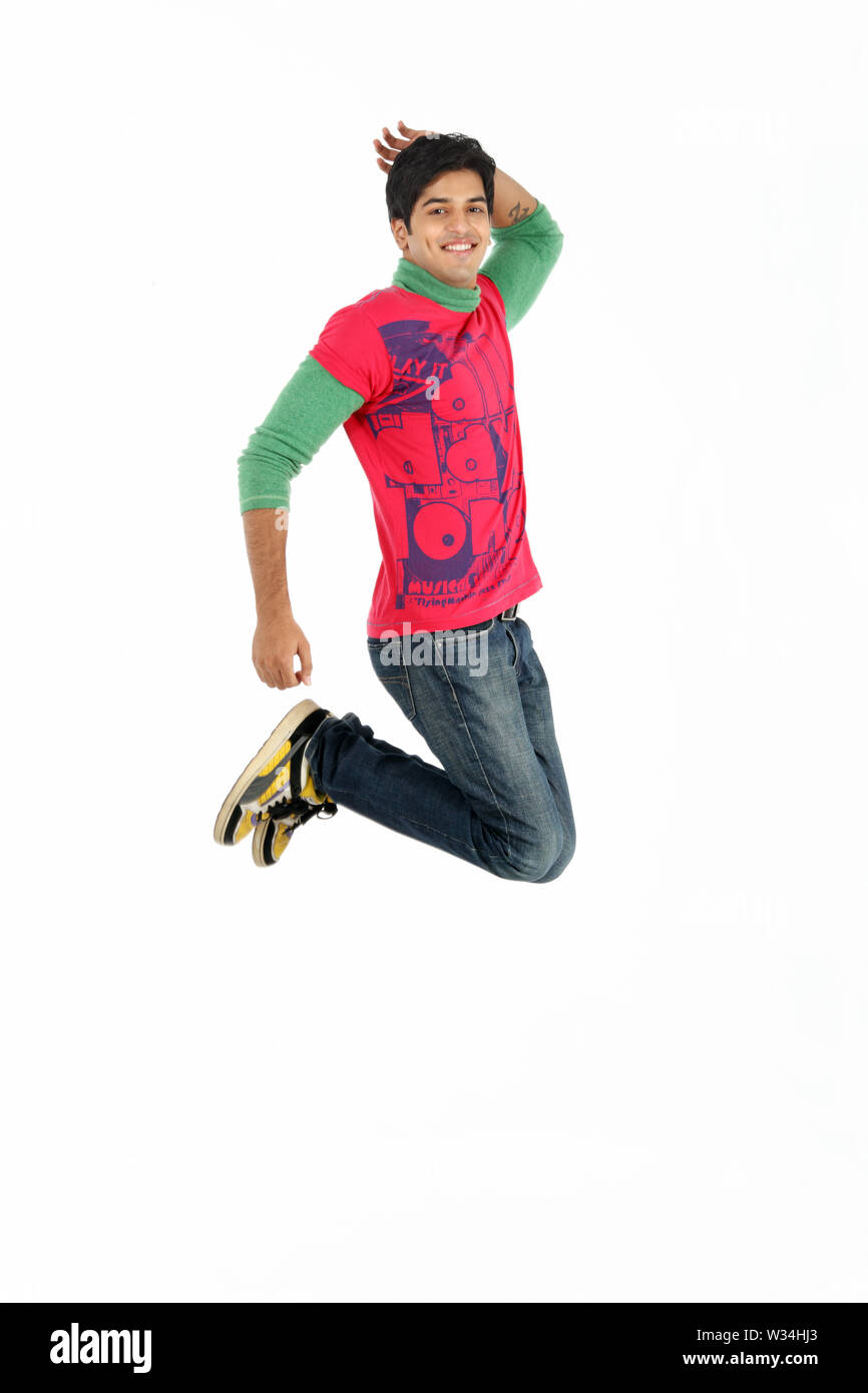 Portrait of an Indian young man jumping in air Stock Photo - Alamy