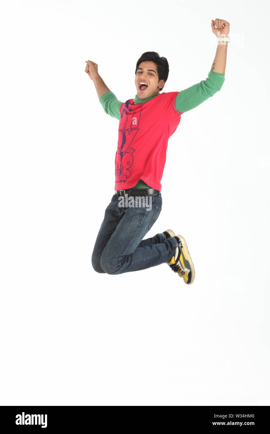 Portrait of a man jumping in air Stock Photo - Alamy