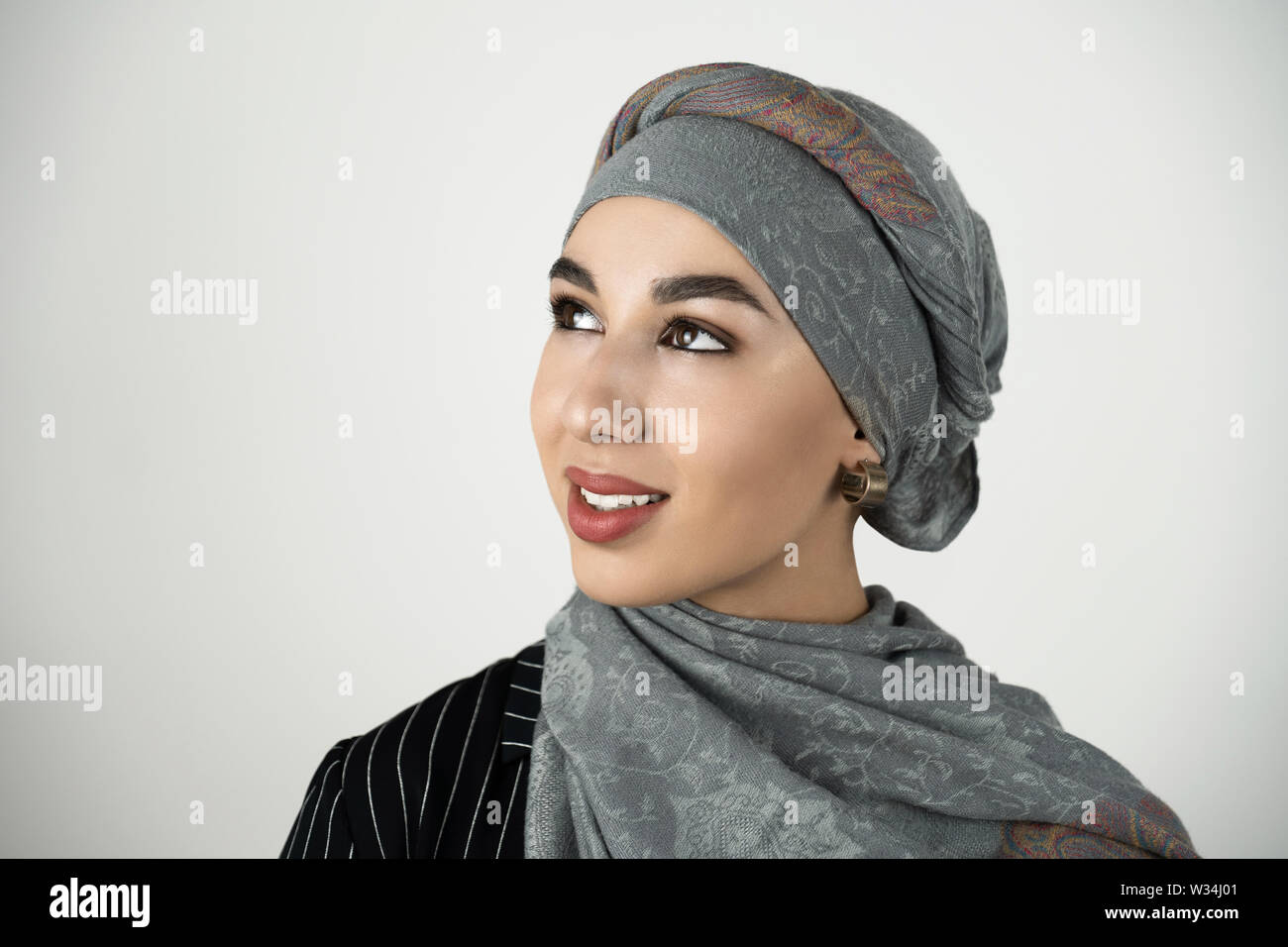 young beautiful Muslim woman wearing turban hijab, headscarf looking ...