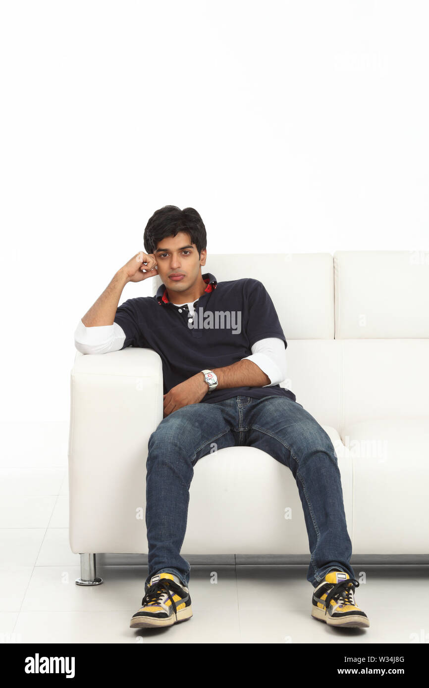 Portrait of a man sitting on couch Stock Photo - Alamy