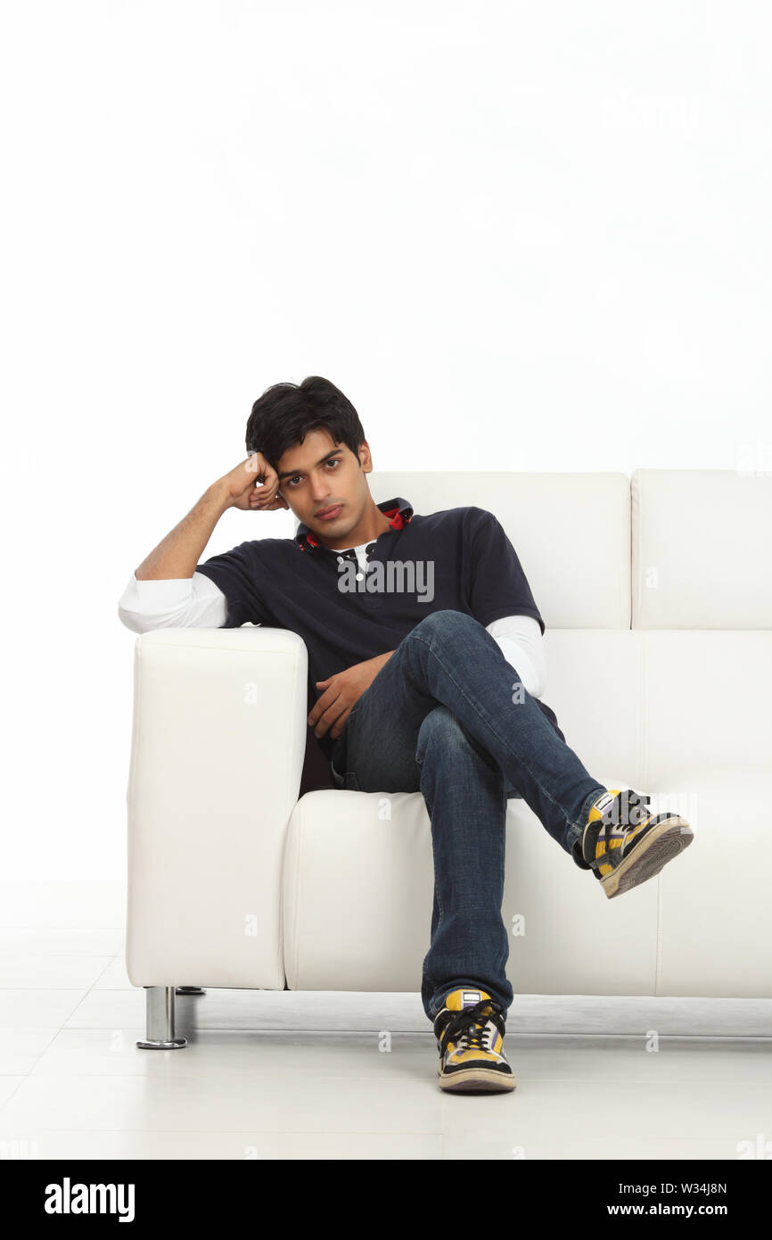 Portrait of a man sitting on couch Stock Photo - Alamy