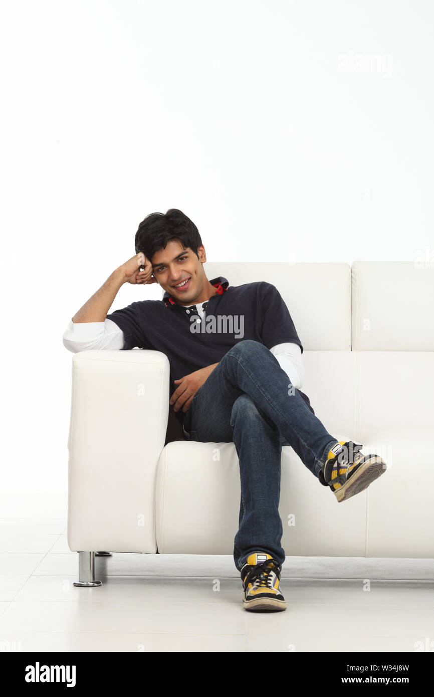 Portrait of a man sitting on couch Stock Photo - Alamy