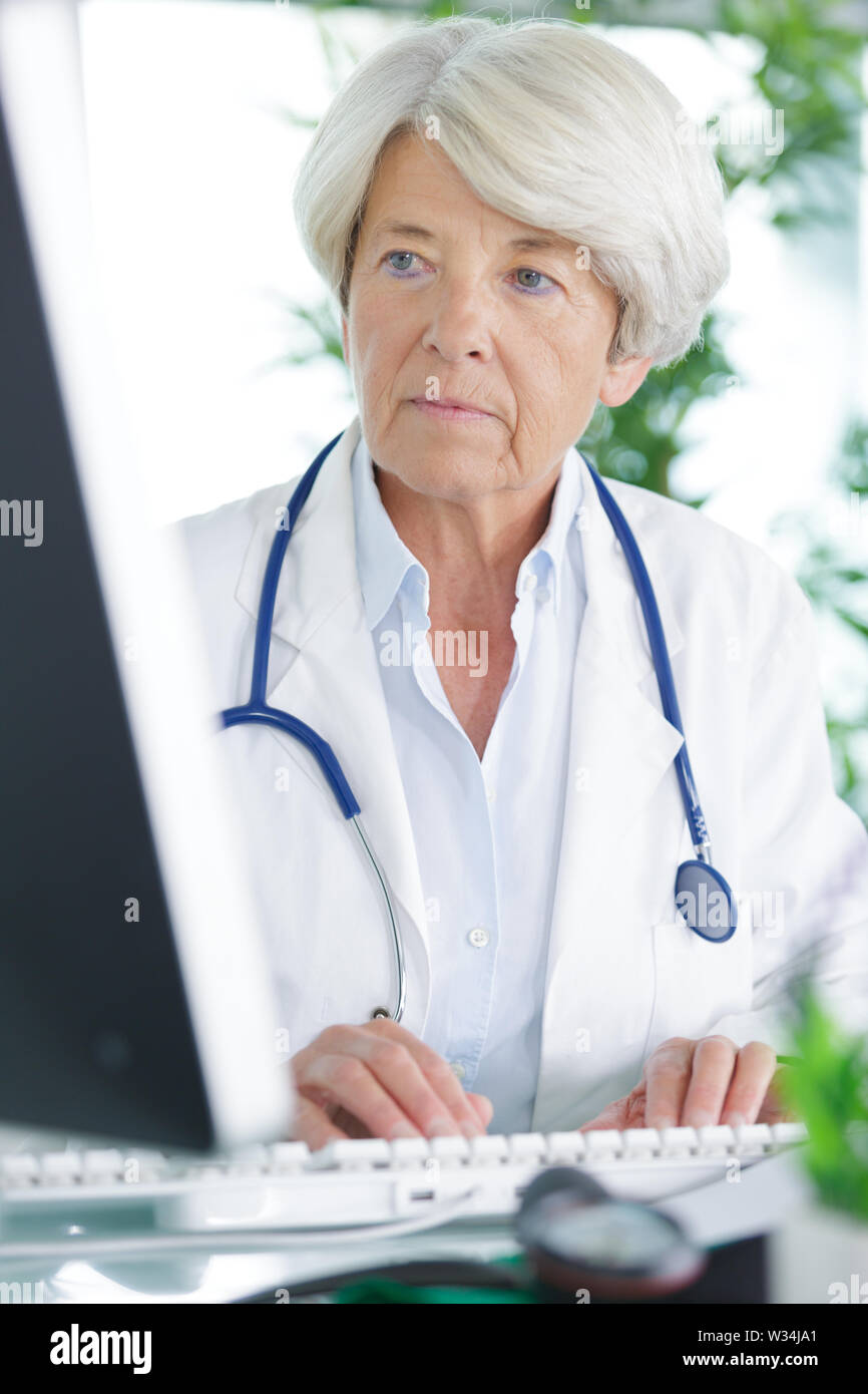 Female doctor typing on computer hi-res stock photography and images ...