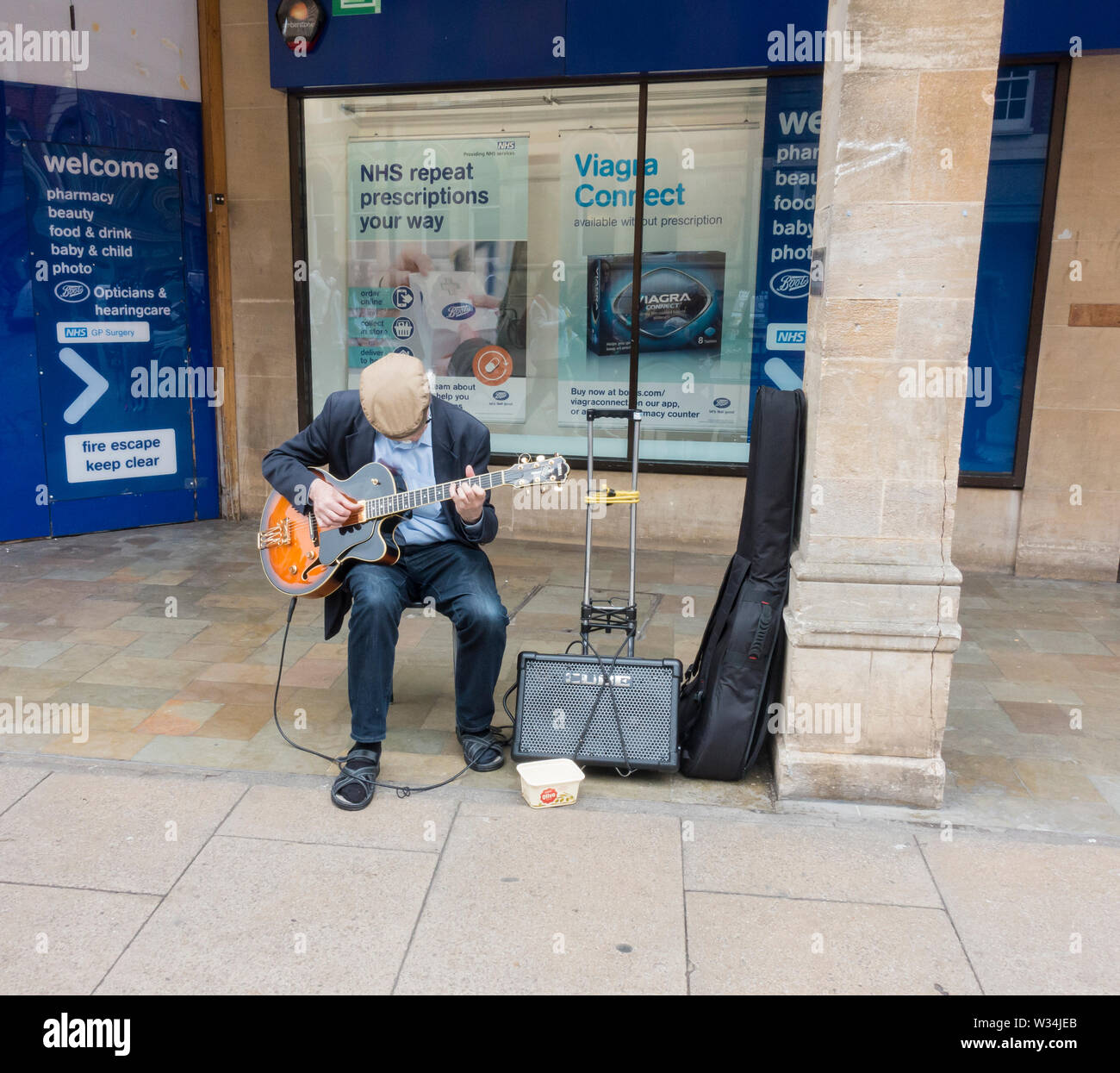 Elderly man busking on guitar hi-res stock photography and images - Alamy