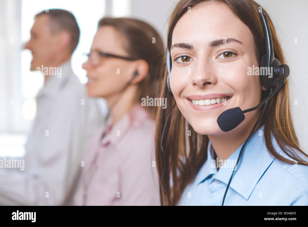 Portrait of a friendly girl working in a call center in a headset Stock ...