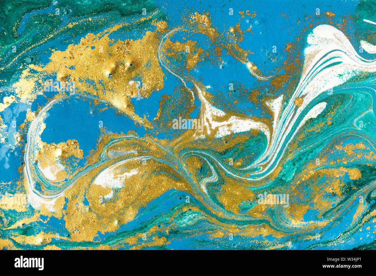 Liquid uneven blue and green marbling pattern with golden glitter and ...