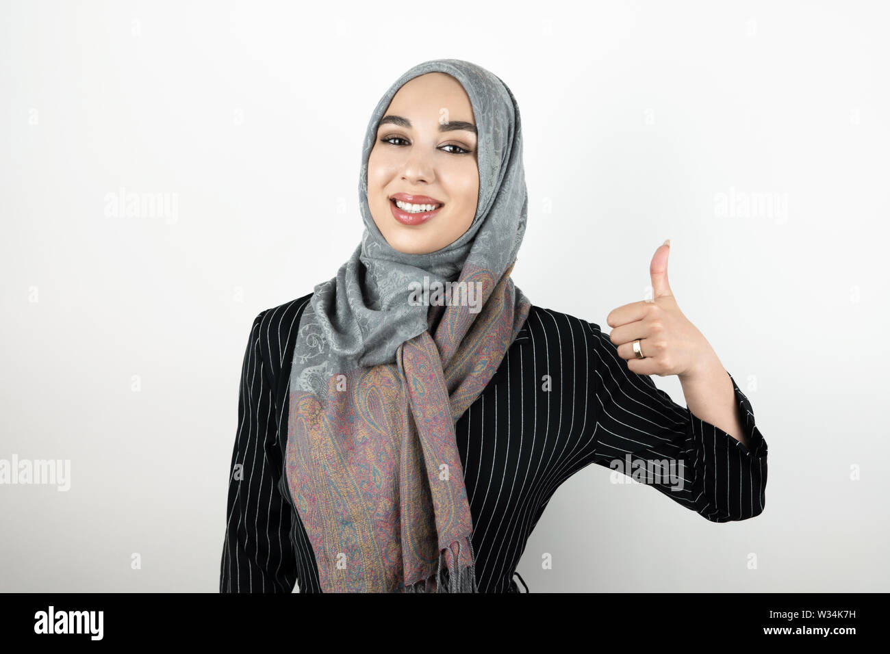 young beautiful smiling positive Muslim woman wearing turban hijab ...