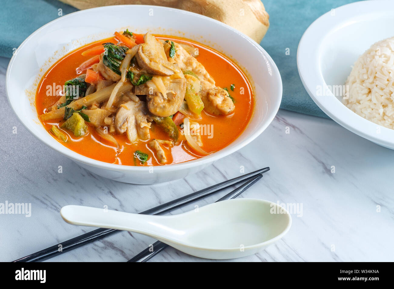 Thai food spicy coconut milk panang curry soup with chicken snow peas ...