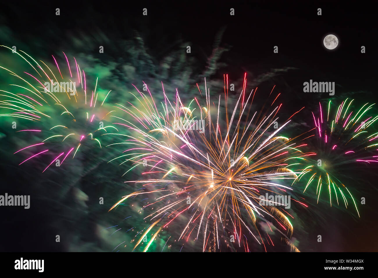 Colorful fireworks against the night sky and the full moon Stock Photo ...