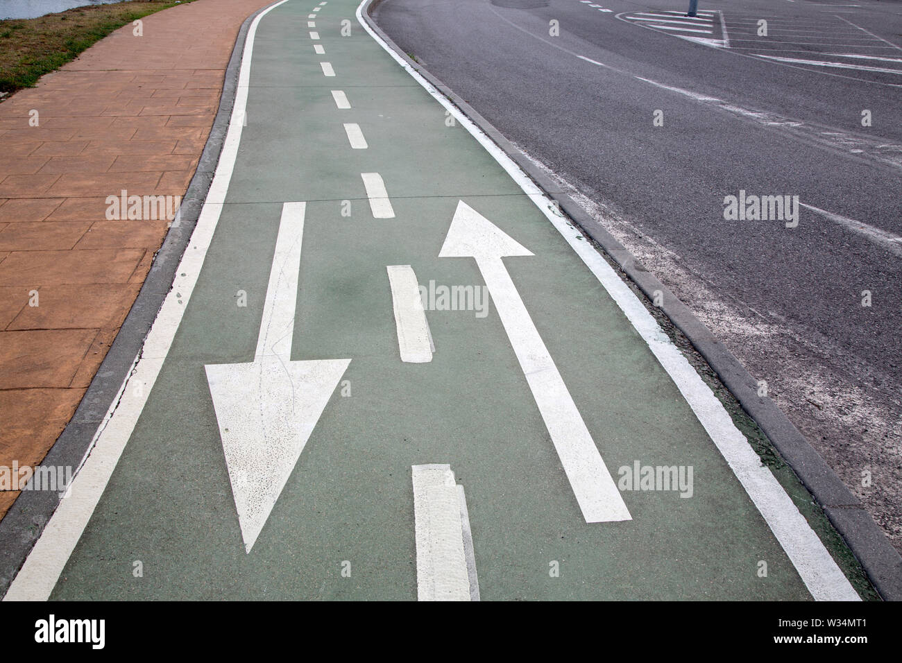 Arrow Symbols on Cycle Path Stock Photo - Alamy