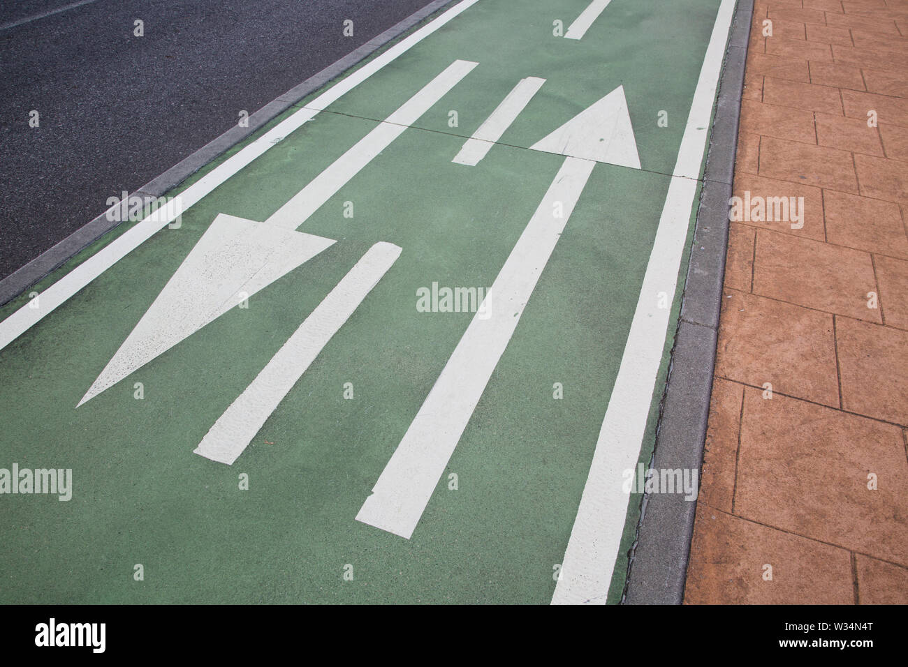 Arrow Symbols on Cycle Lane Stock Photo - Alamy