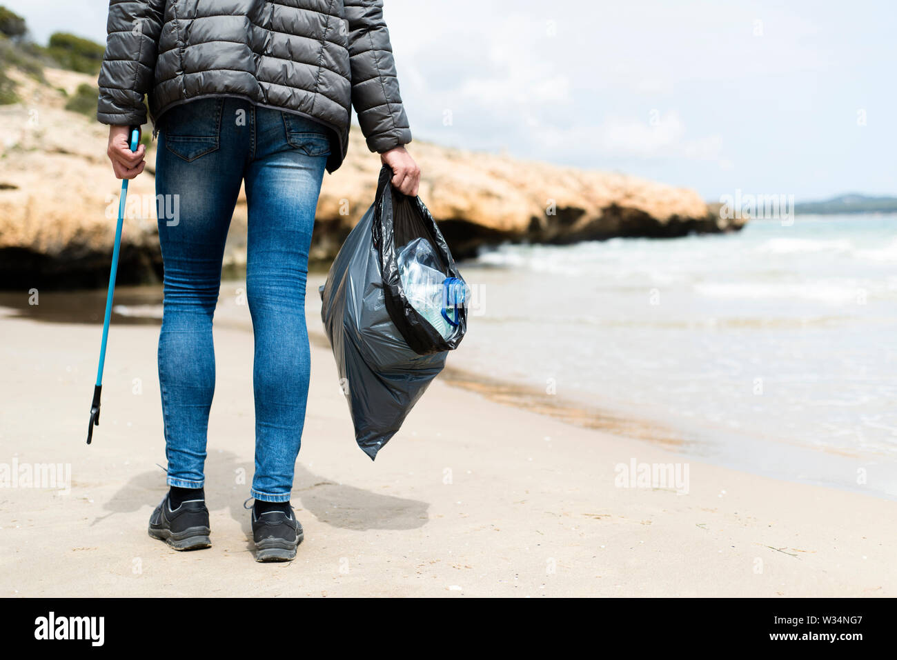Volunteer seen collecting garbage hi-res stock photography and images ...