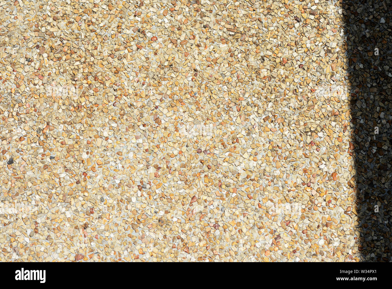 Pebble stone floor texture close up with shadow on it. Abstract ...