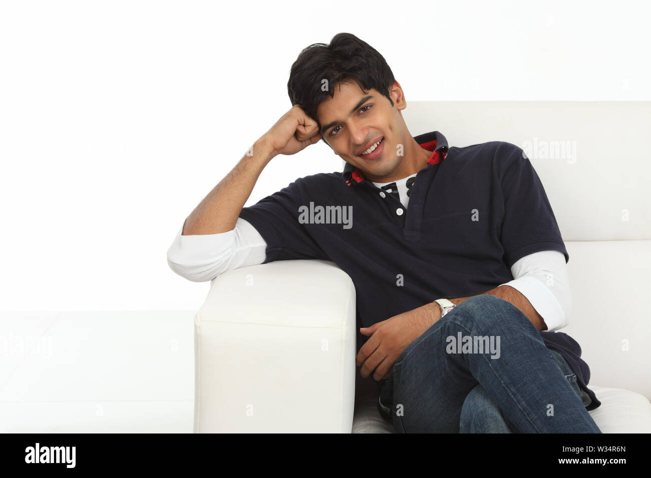Portrait of a man sitting on couch Stock Photo - Alamy
