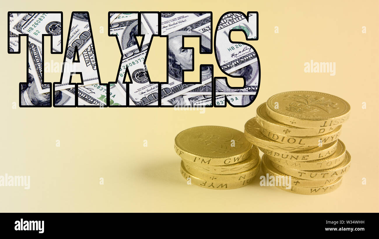 "TAXES" word with notes inscribed and coin stack in front. Pile of ...