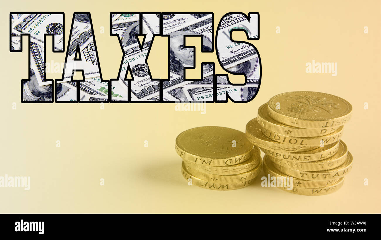 "TAXES" word with notes inscribed and coin stack in front. Pile of ...