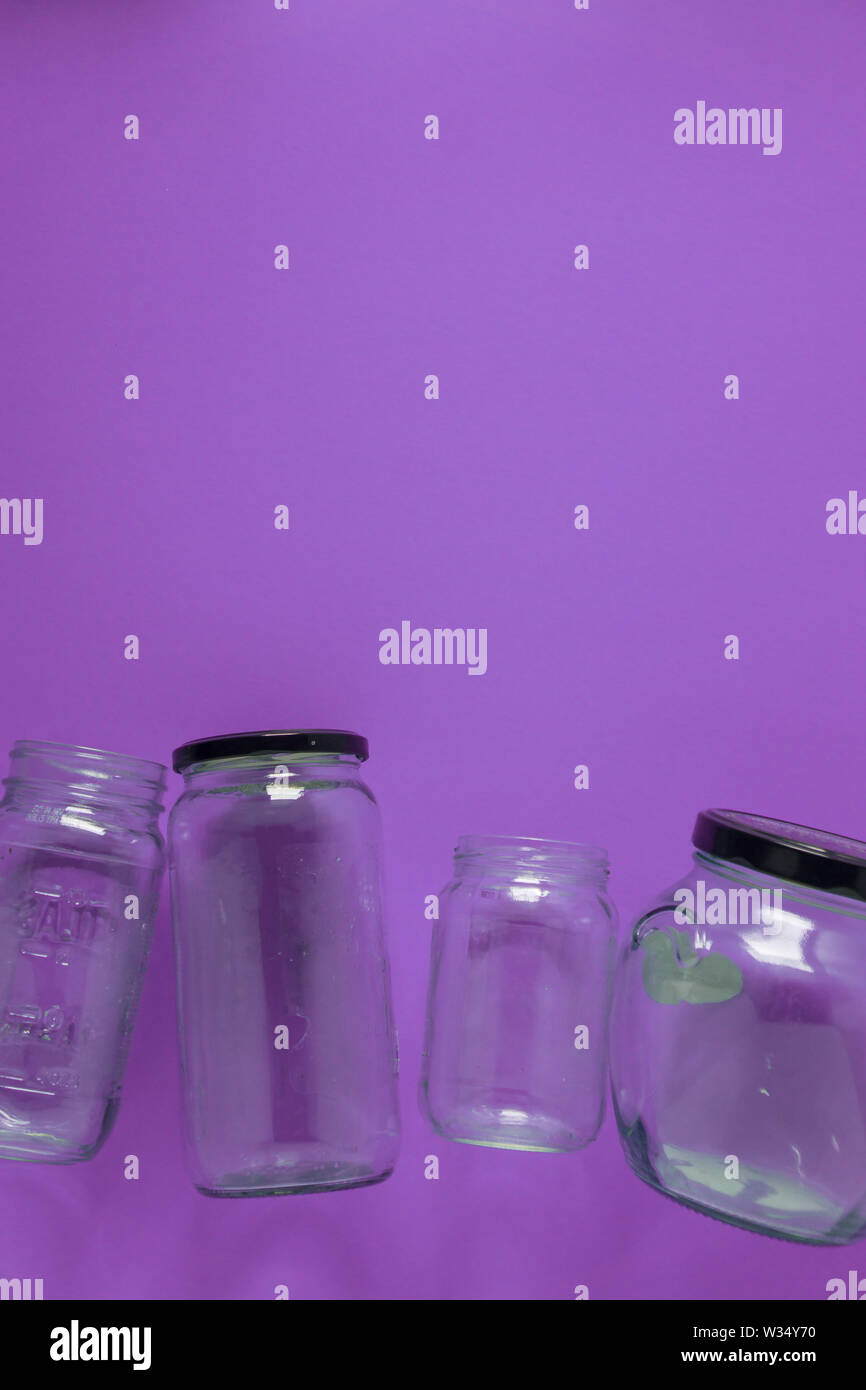 Isolated glass jars, flat on violet purple background, blank empty room ...