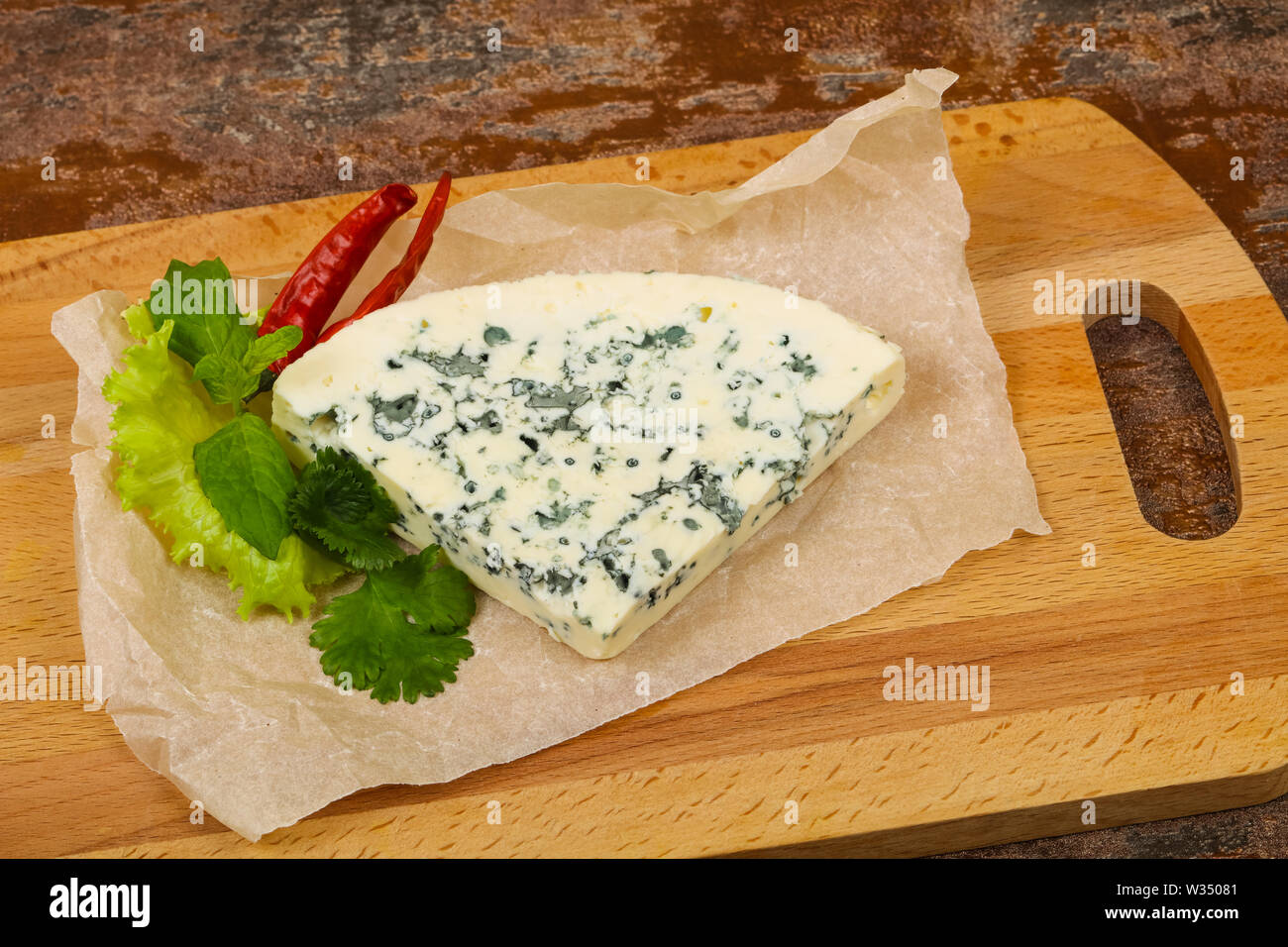 Blue cheese slice with salad leaves Stock Photo - Alamy