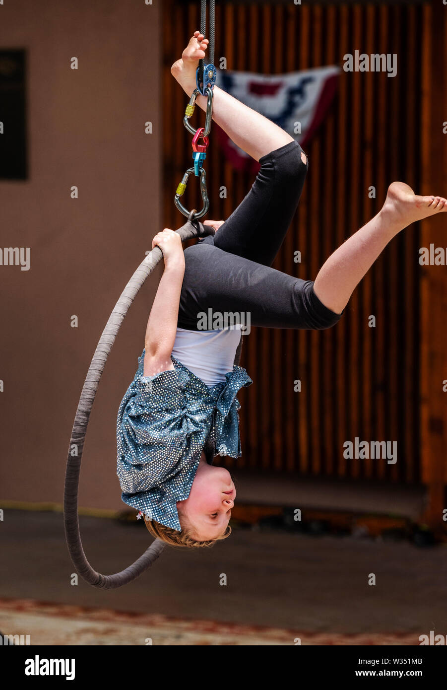 Young girl performing on circus rings hoops Lyras; Fourth of July event ...