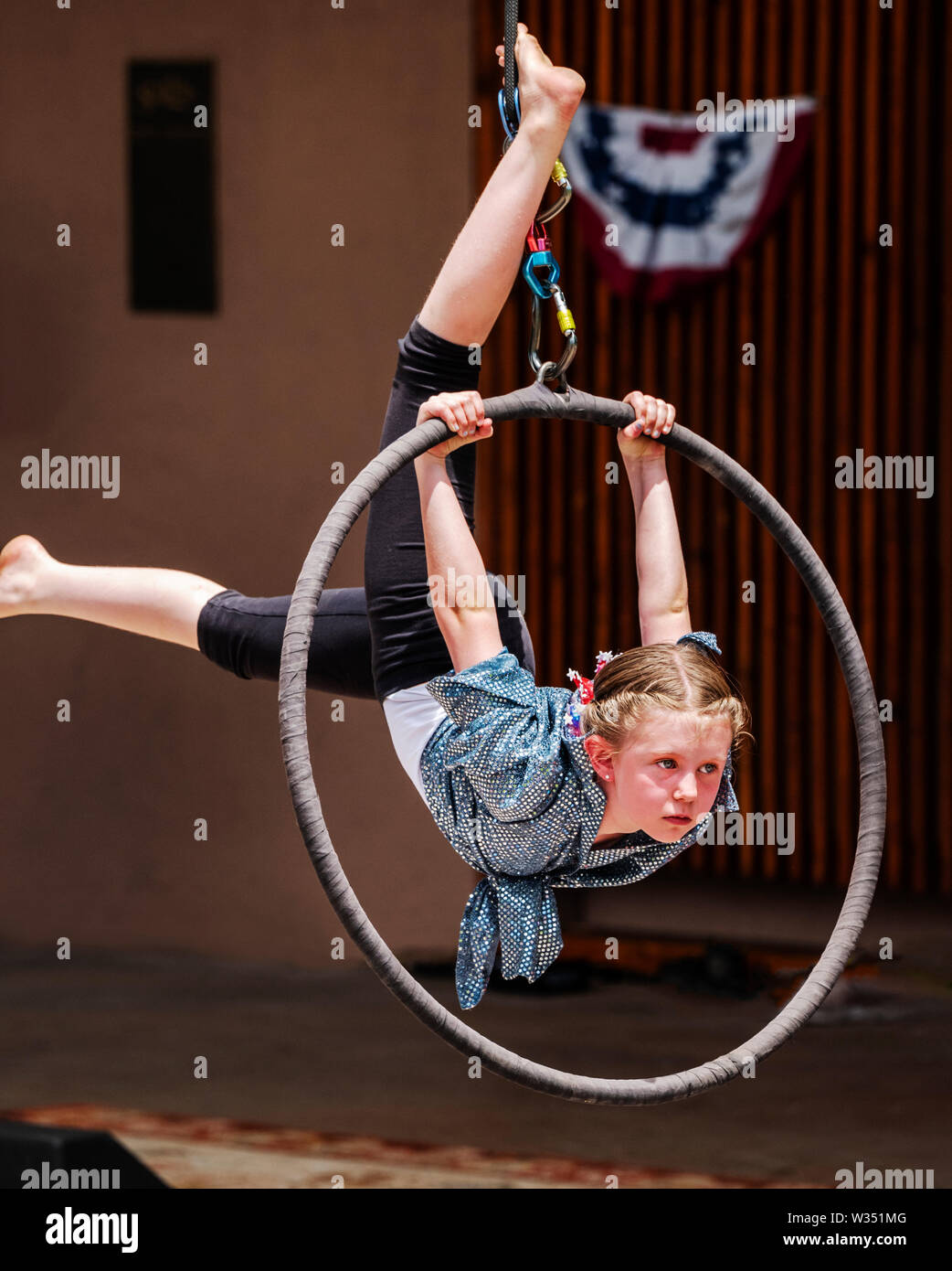 Young girl performing on circus rings hoops Lyras; Fourth of July event ...