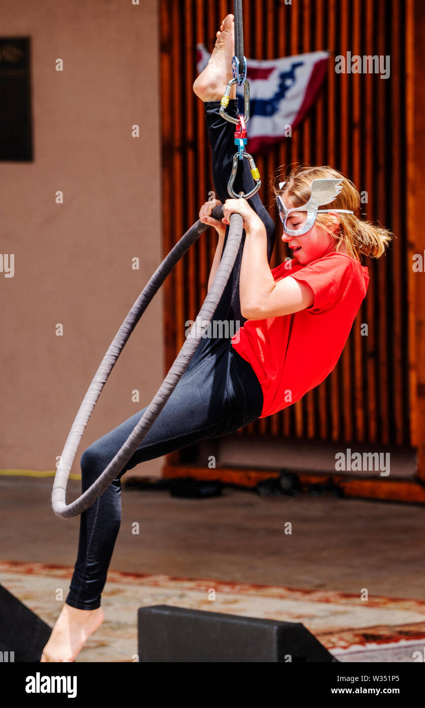 Young girl performing on circus rings hoops Lyras; Fourth of July event ...
