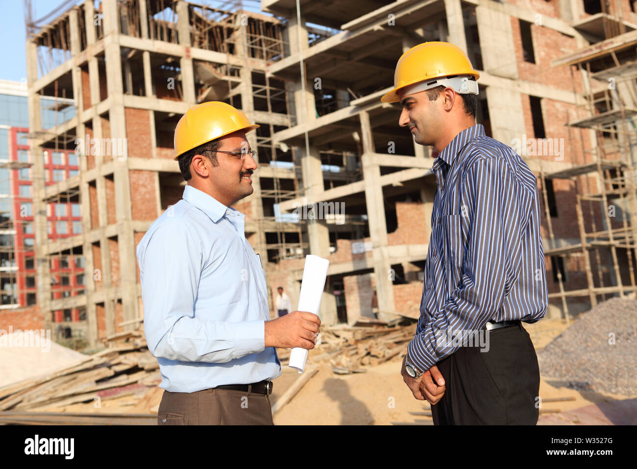 Two engineers discussing at a construction site Stock Photo - Alamy