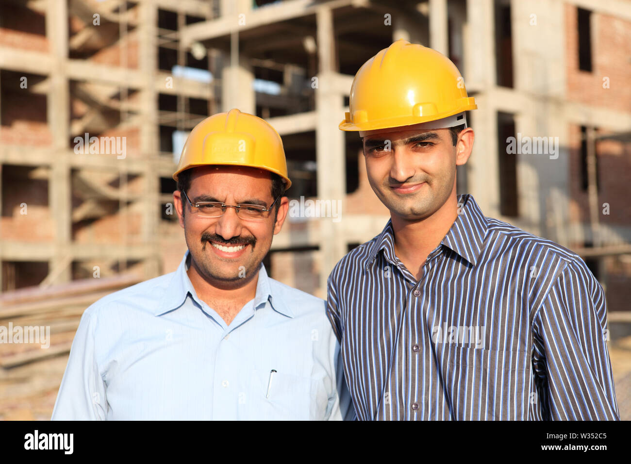 Portrait of two Indian engineers at a construction site Stock Photo - Alamy