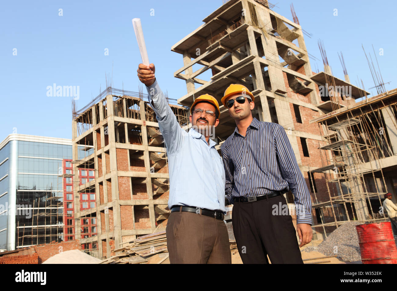 Two Indian engineers discussing at a construction site Stock Photo - Alamy
