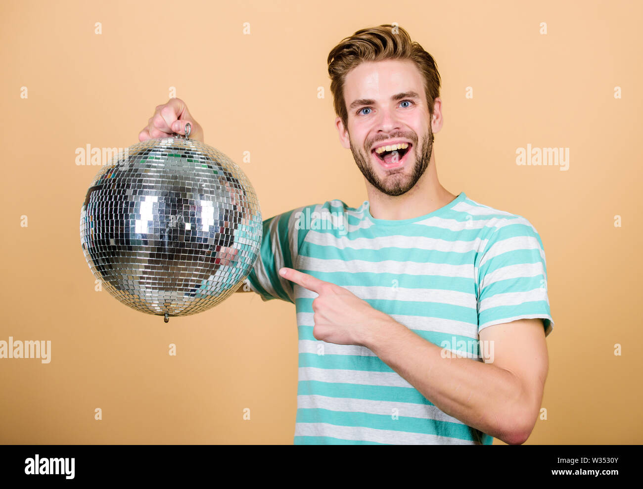 How about party. Handsome man hold disco ball. Disco dances night club ...